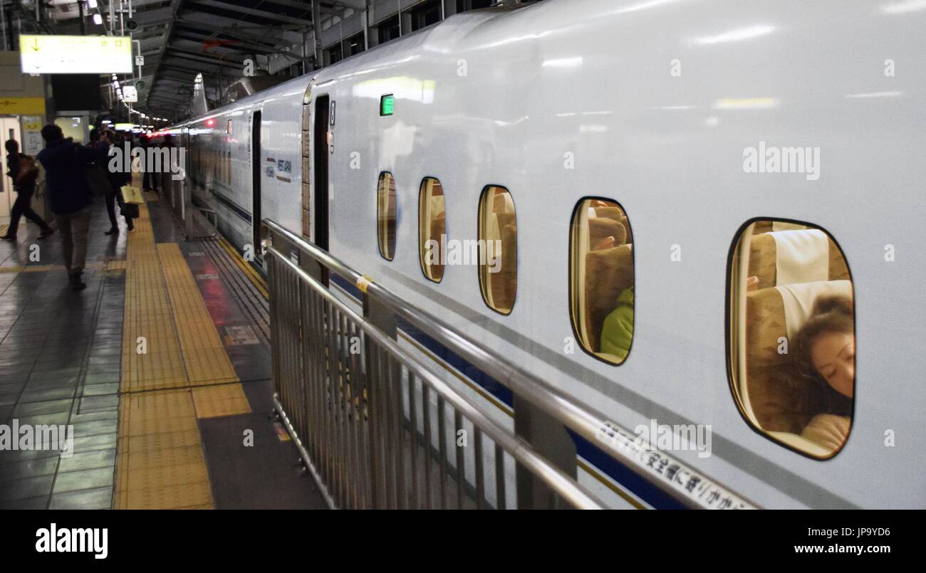 A shinkansen bullet train arrives at JR Okayama Station in Okayama ...