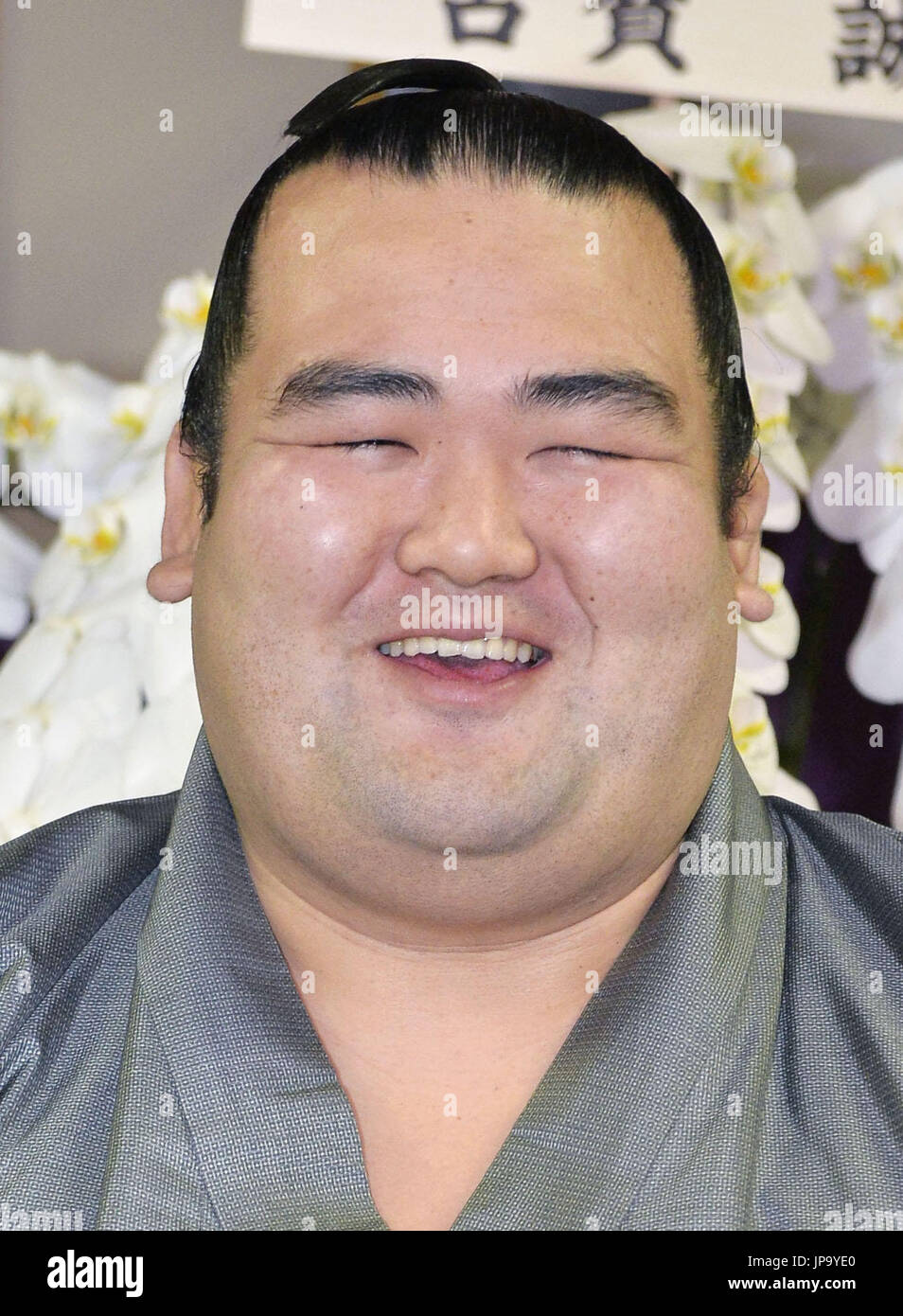 Sumo wrestler Kotoshogiku smiles during a press conference at his ...