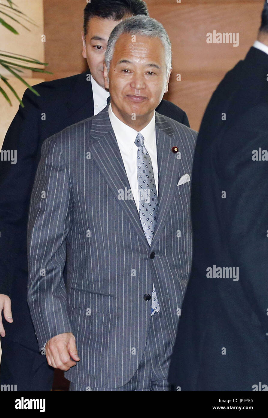 Japanese Economic and Fiscal Policy Minister Akira Amari leaves the ...