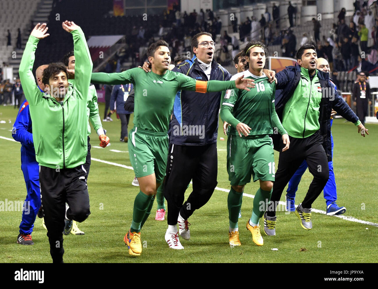Iraqi players celebrate after defeating Qatar 2-1 in extra time in the ...
