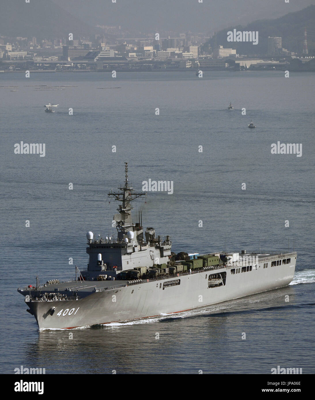 Photo taken from a Kyodo News helicopter shows a transport vessel ...