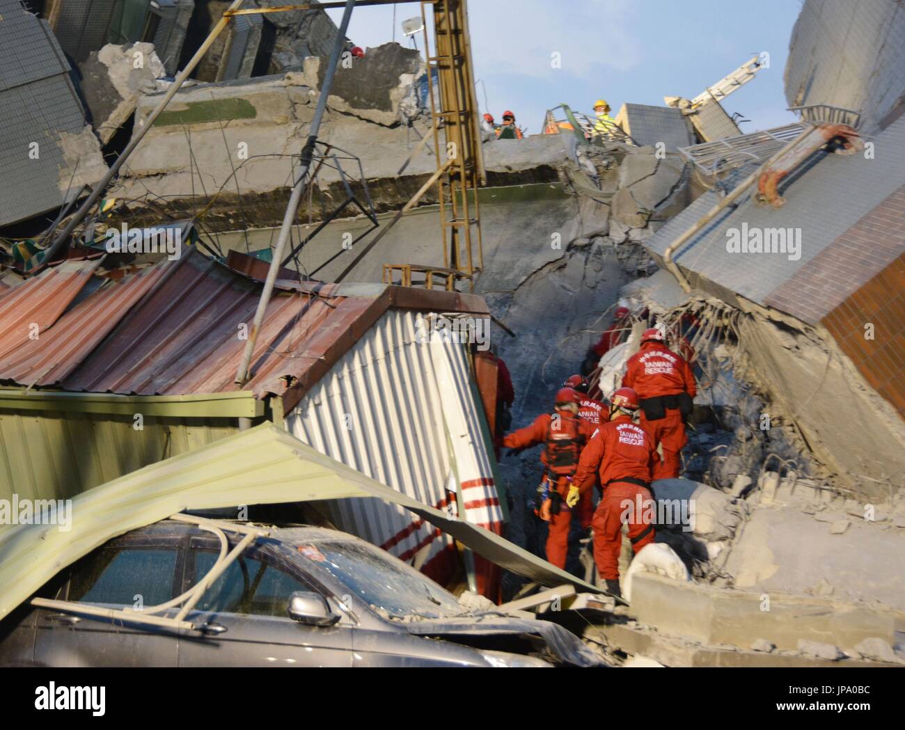 Rescue workers search for people believed to be trapped inside a ...