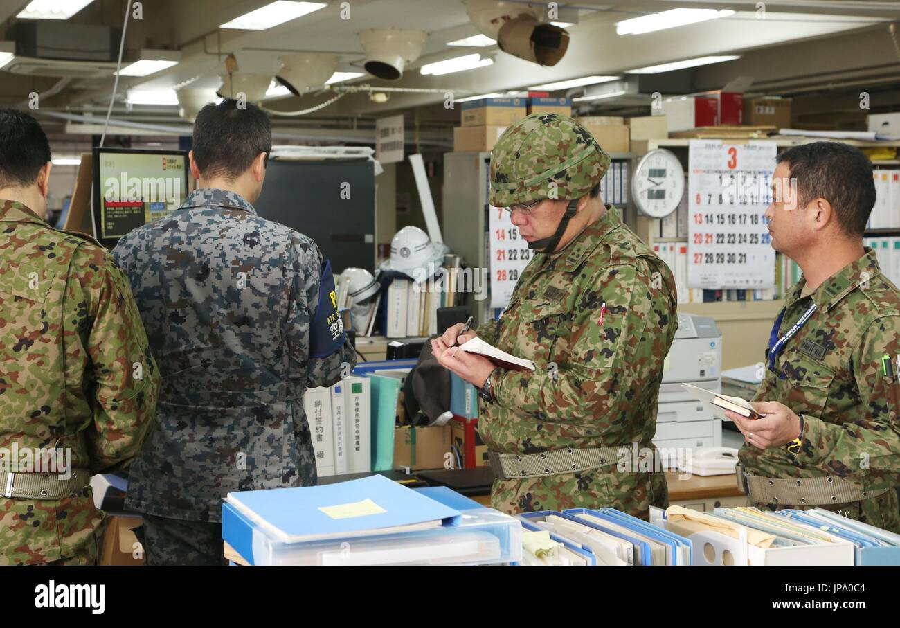 Japan's Self-Defense Forces personnel gather information at the ...