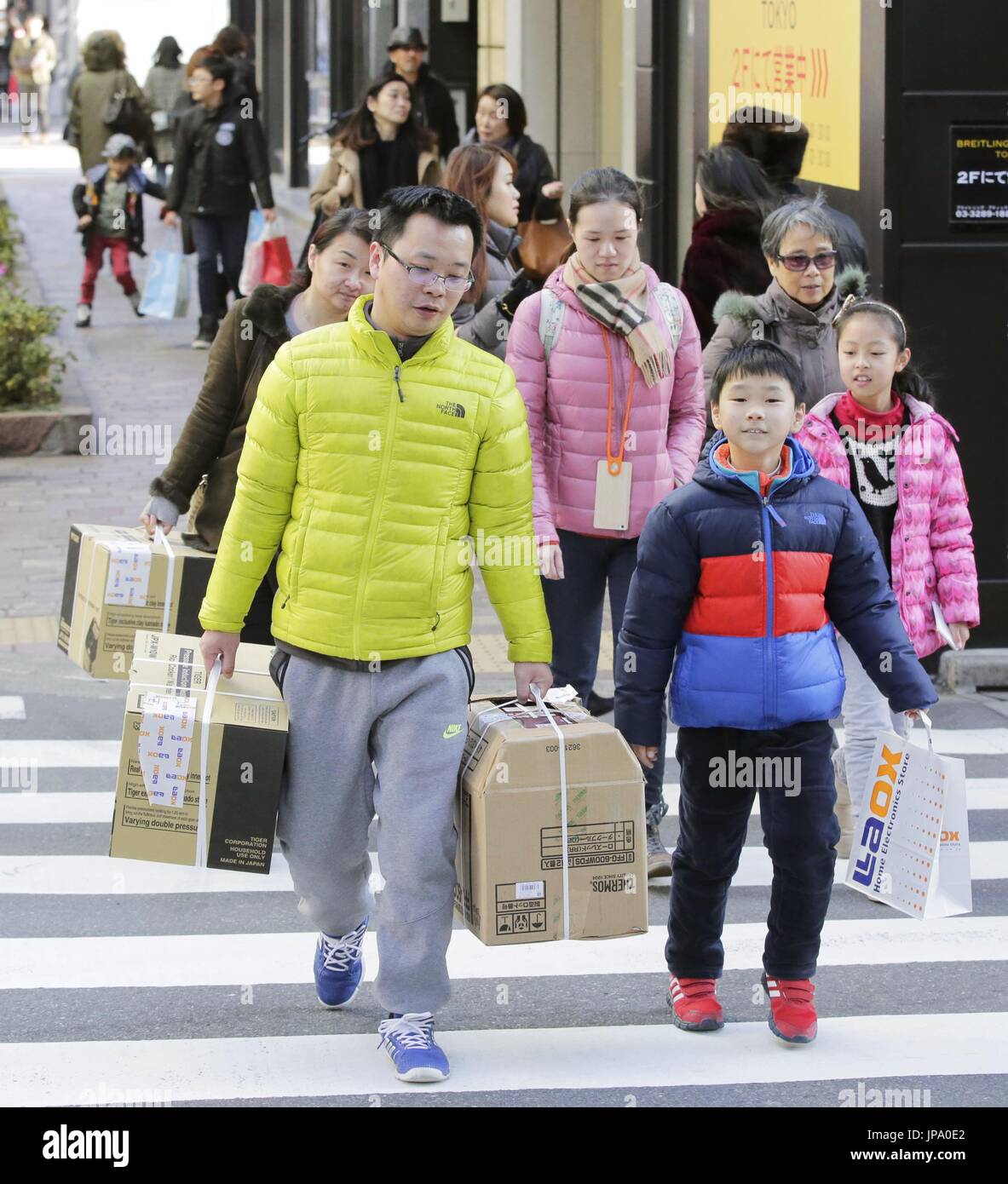 Chinese travelers walk in Tokyo's Ginza shopping district on Feb. 7 ...