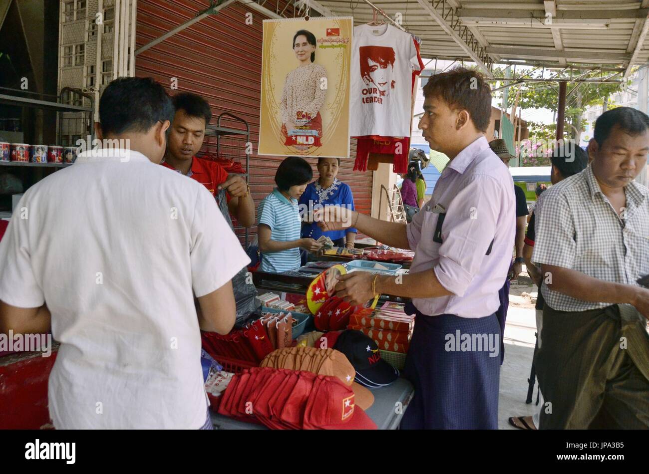 People visit a merchandise shop in front of the Yangon headquarters of ...
