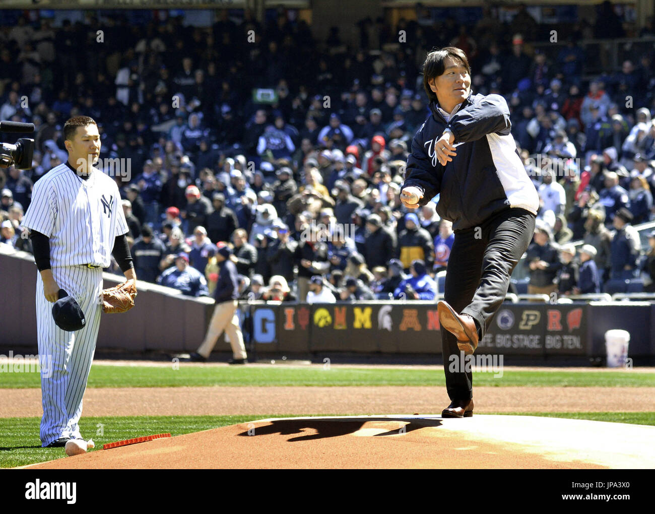 Former New York Yankees slugger Hideki Matsui (R) throws out the ceremonial first pitch before ...