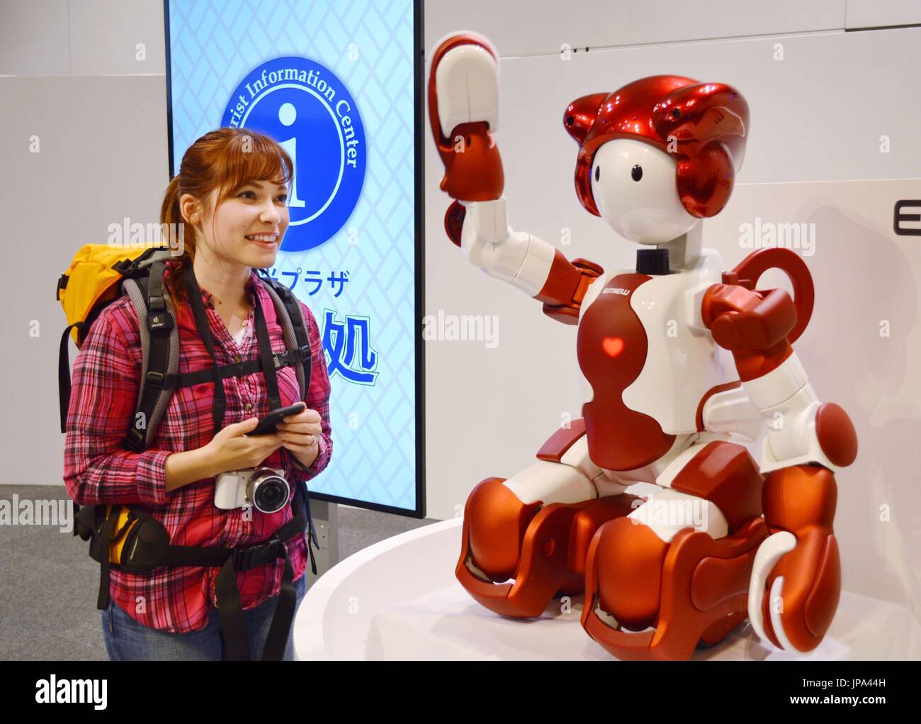 The EMIEW3 humanoid robot developed by Hitachi Ltd. interacts with a ...