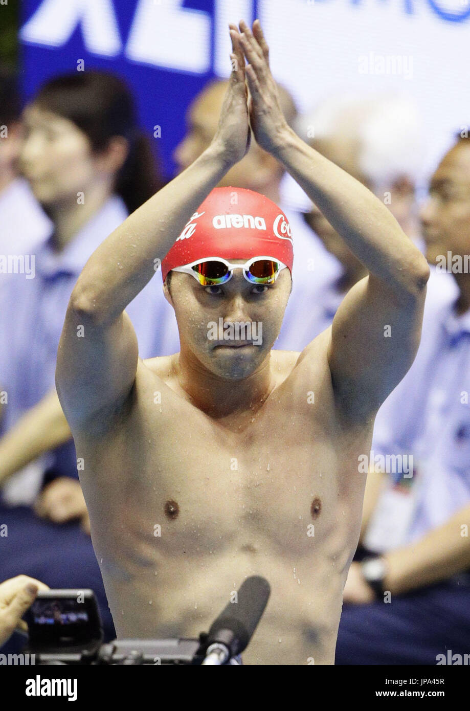 Former two-time double Olympic breaststroke champion Kosuke Kitajima responds to the crowd after ...
