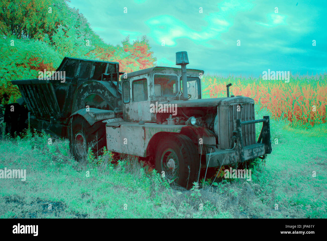 Rusting heavy farm equipment in field in infrared Stock Photo - Alamy