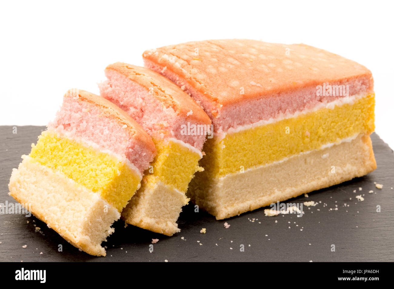 Angel cake is a three colour layered sponge cake - white background ...