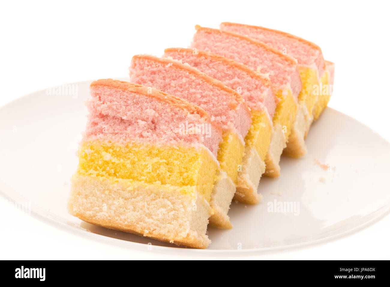 Angel cake is a three colour layered sponge cake - white background ...