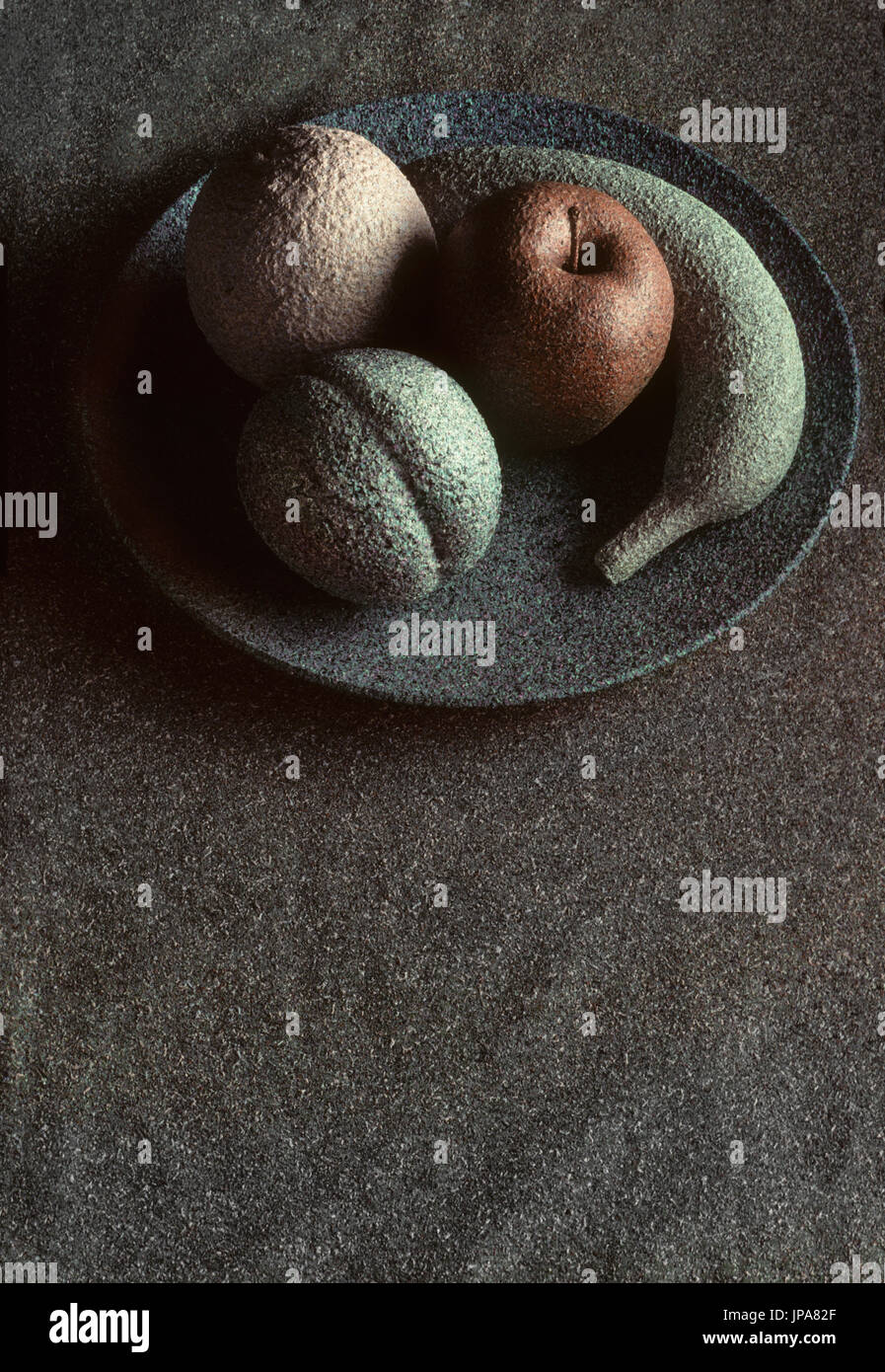 Granite-like sculpture of fruit on a plate Stock Photo - Alamy