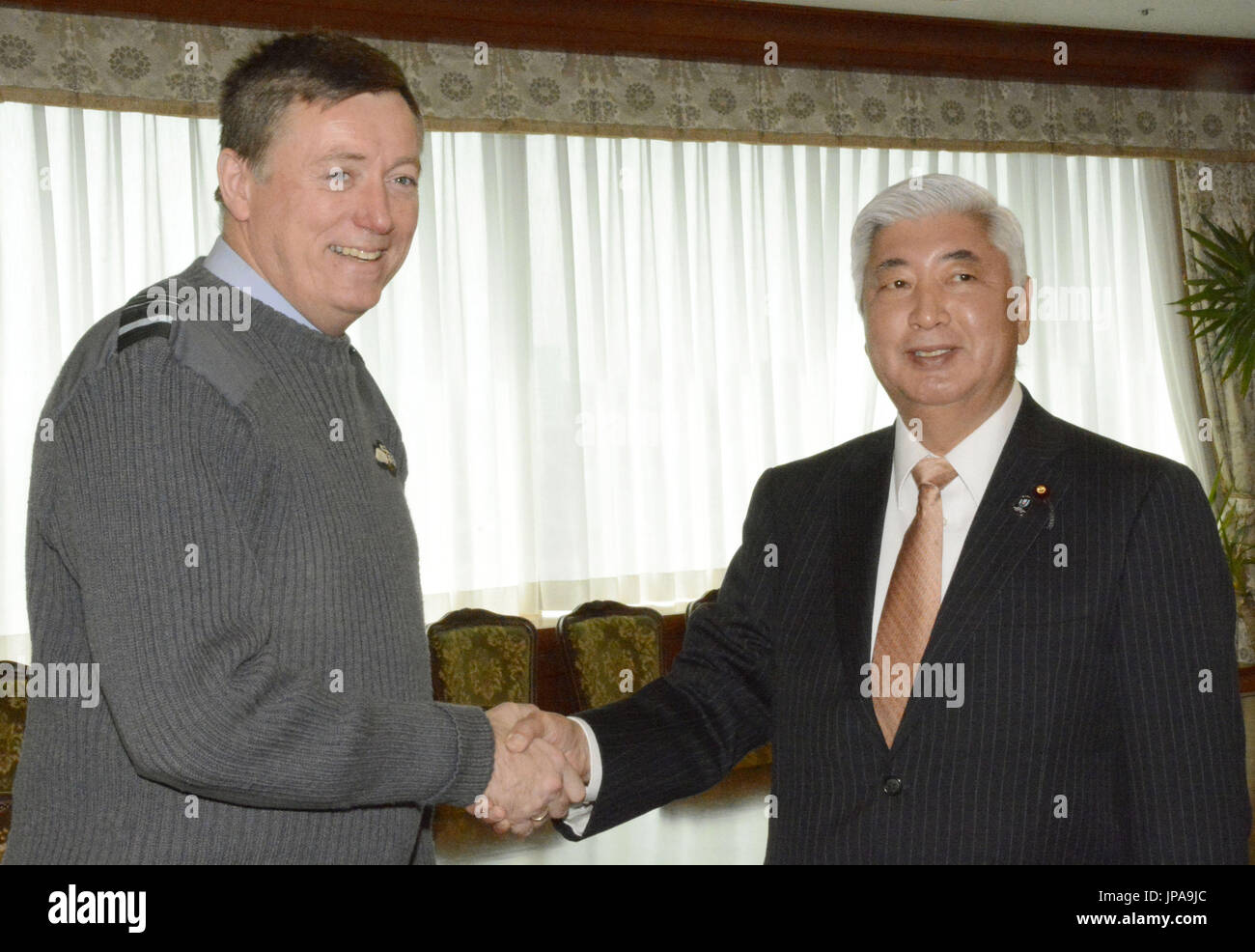 Japanese Defense Minister Gen Nakatani (R) shakes hands with Air ...