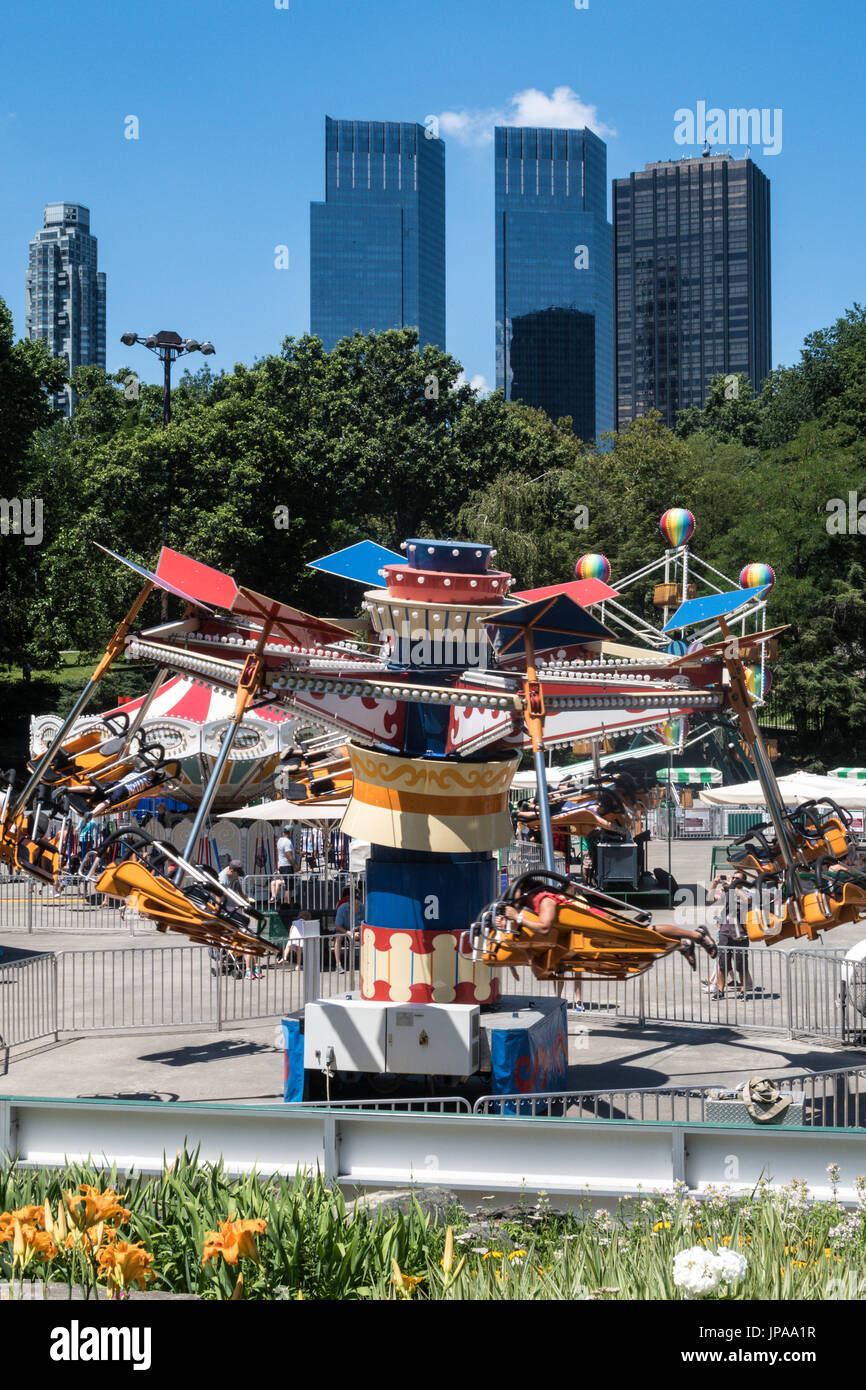 Victorian Gardens, Carnival Rides in Central Park with Skyline in ...