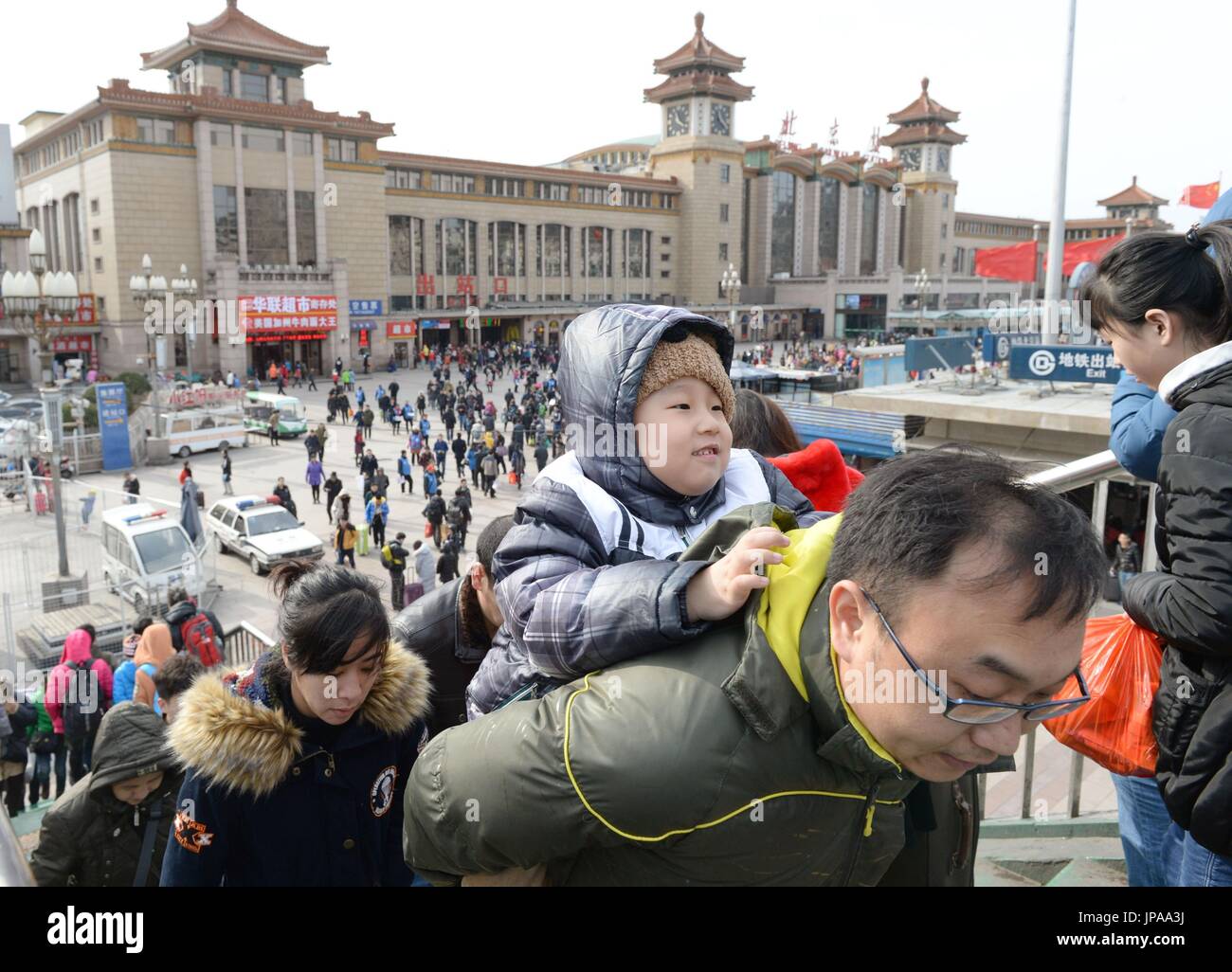 Large numbers of travelers are pictured outside Beijing Station in the ...