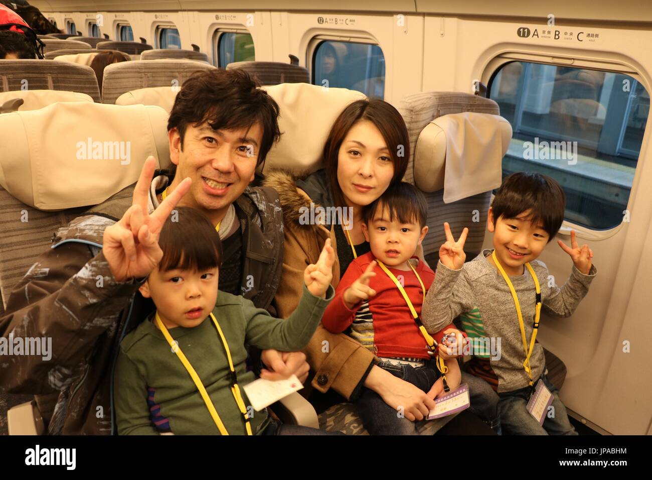 A family rides the Hokkaido Shinkansen bullet train during a test run ...