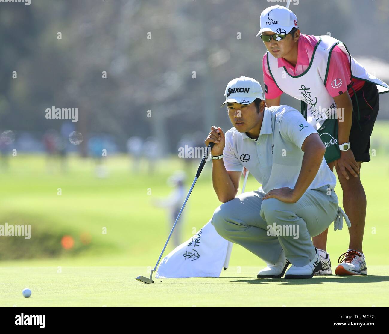 Japanese golfer Hideki Matsuyama lines up a putt on the eighth green ...