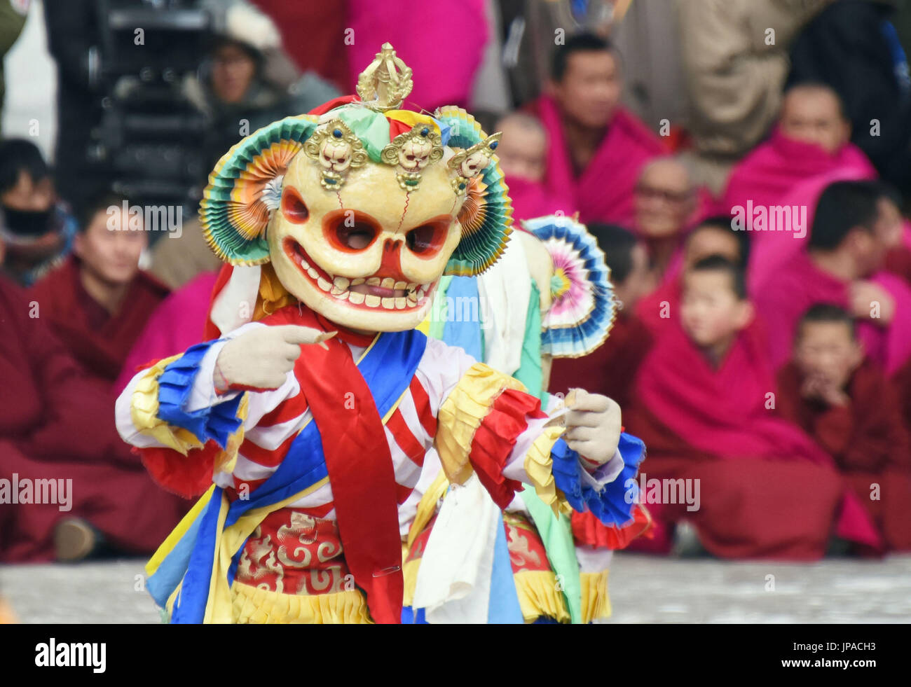 A dancer performs a Tibetan ritual Cham or mask dance at Labrang ...