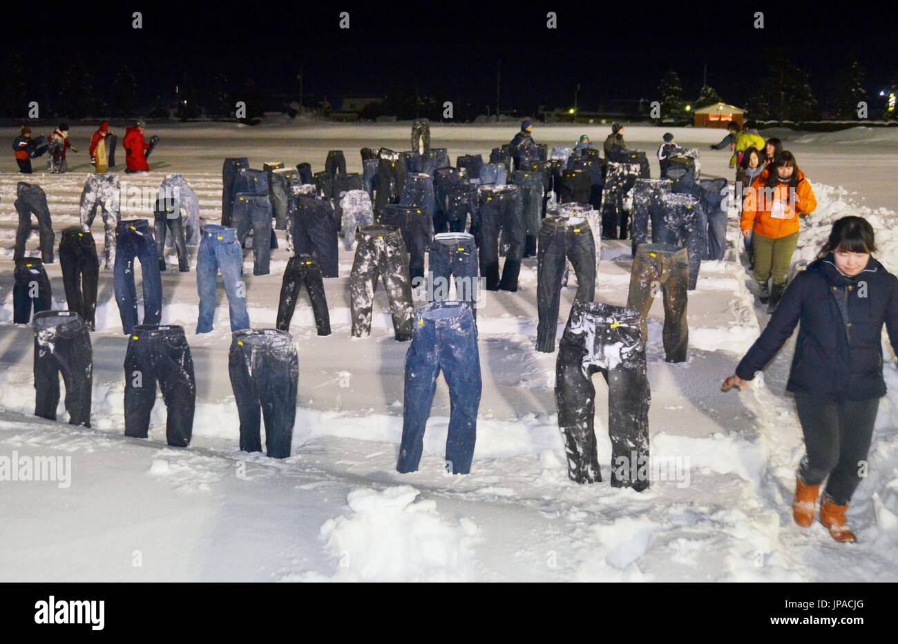 Pairs of jeans, frozen after being soaked in water and then exposed to ...