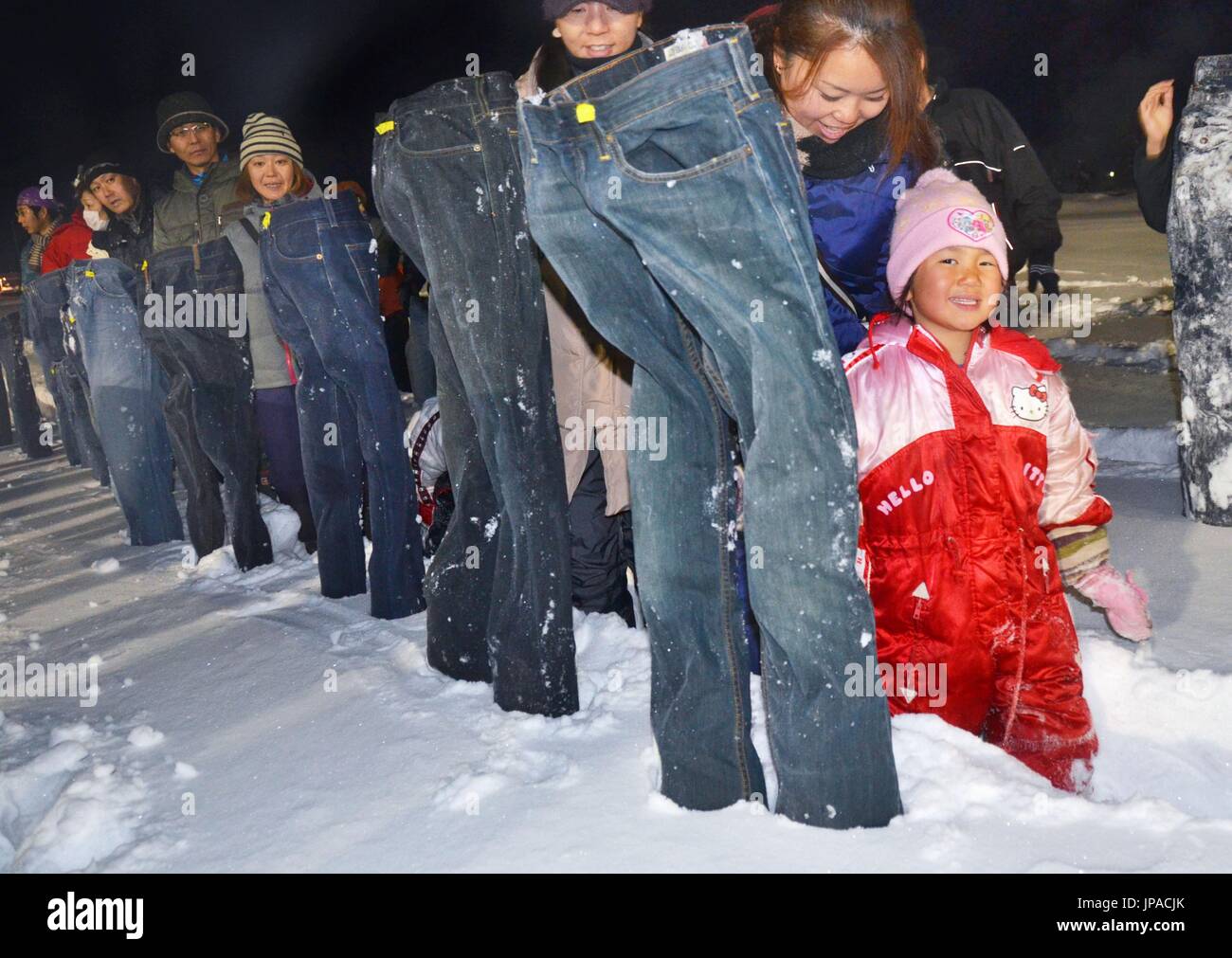 People erect pairs of jeans, frozen after being soaked in water and ...