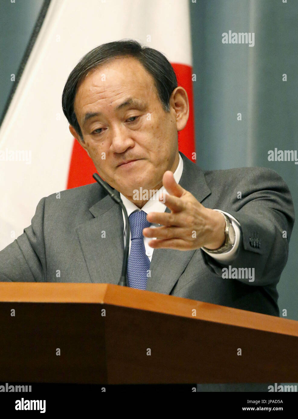 Japanese Chief Cabinet Secretary Yoshihide Suga tells a press ...