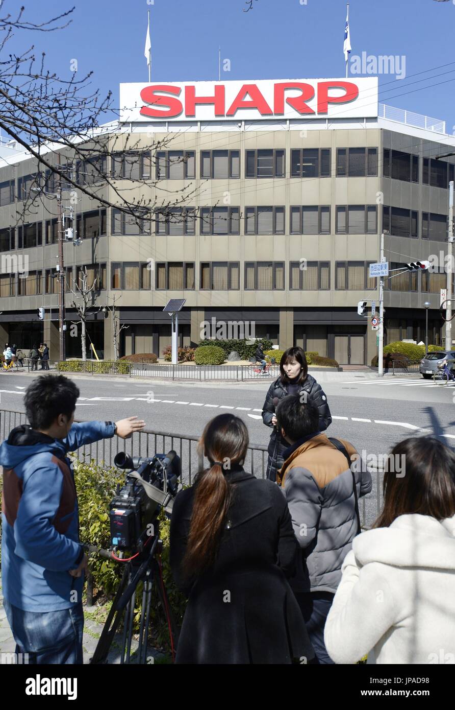 Reporters and photographers gather in front of Sharp Corp.'s head ...