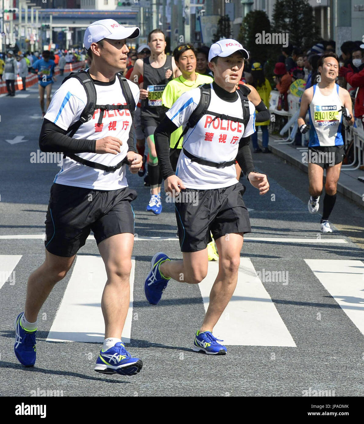 Police officers in running attire are seen along with participants ...