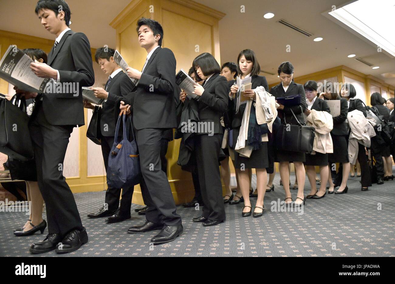 College students queue up to attend a joint briefing by companies in ...