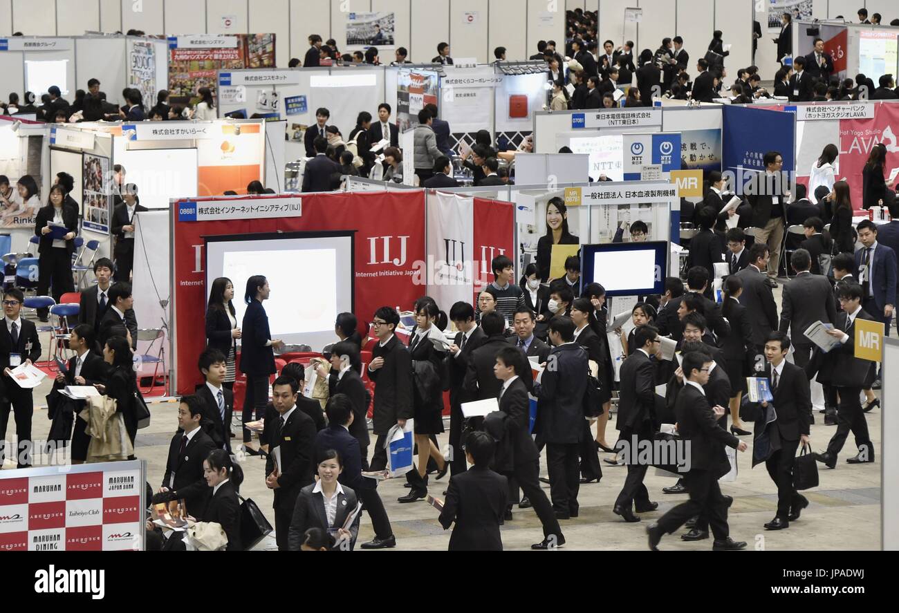 College students visit company booths during a joint corporate ...