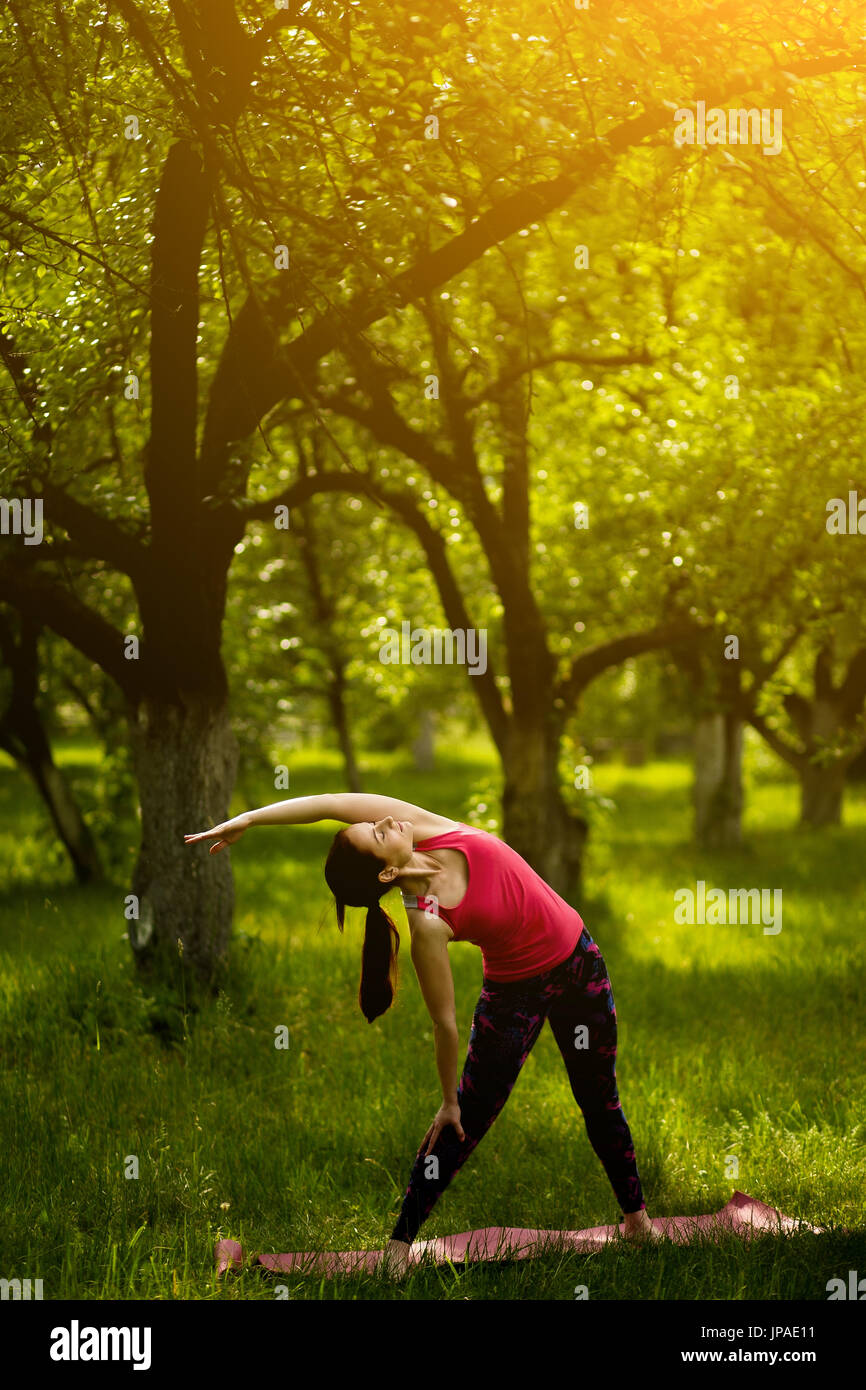 Young female practicing yoga in extended triangle pose Stock Photo - Alamy