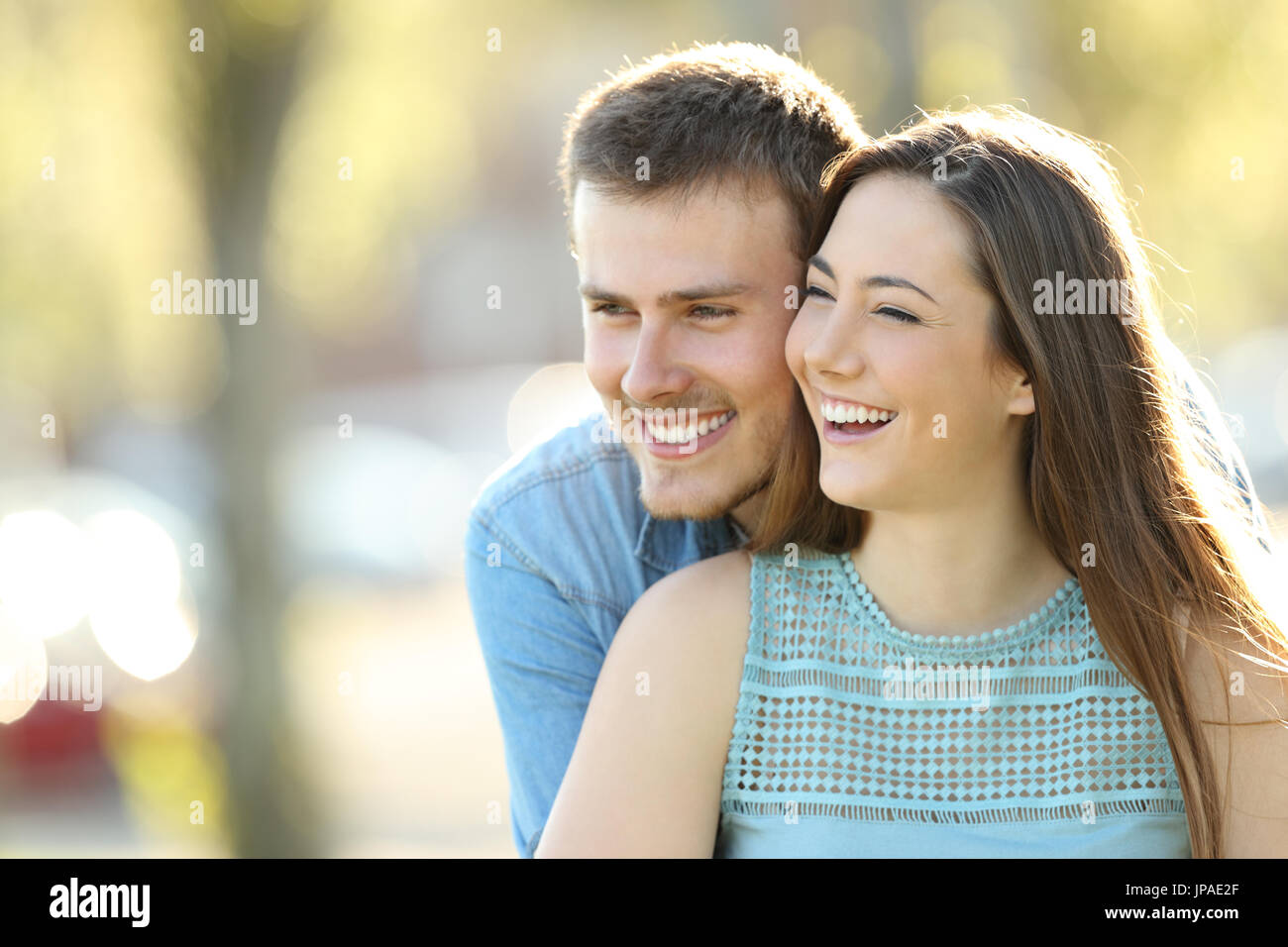 Girlfriend being hugged by her partner outdoors in the street Stock ...