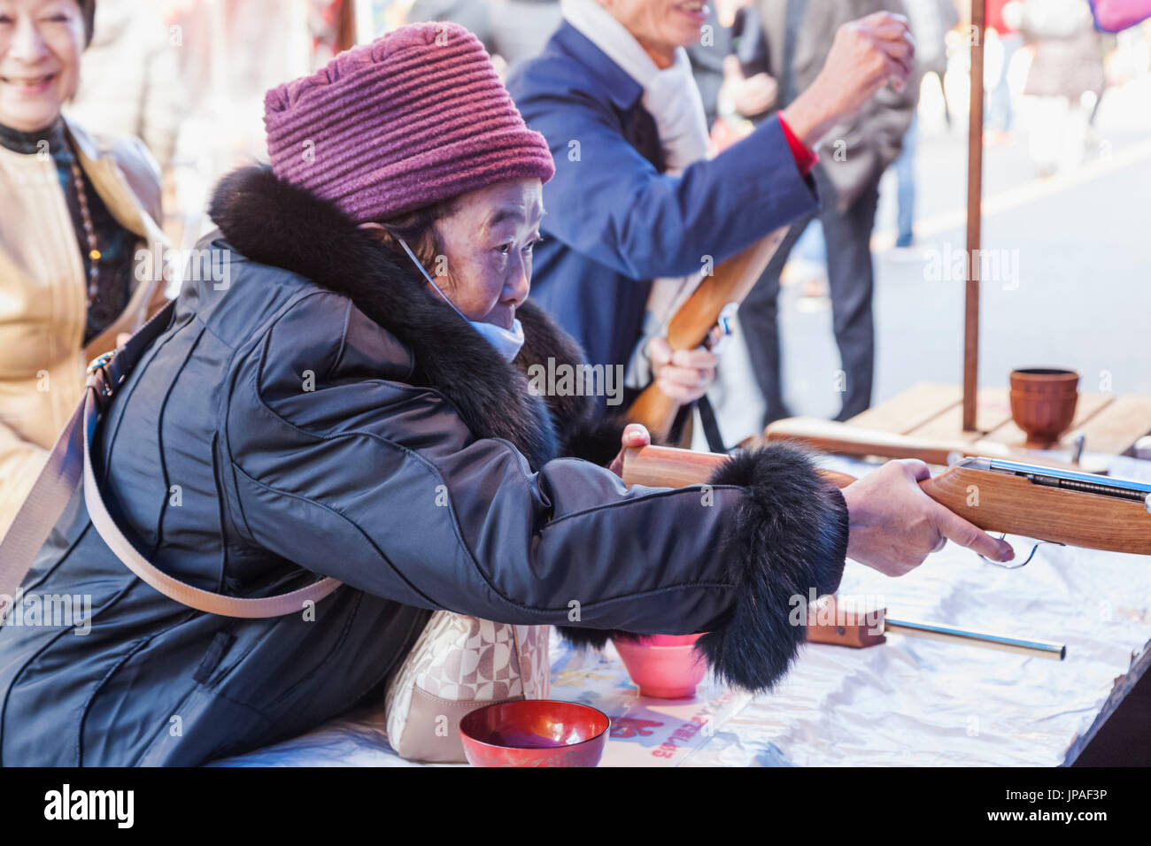 Japan, Honshu, Tokyo, Asakusa, Elderly Lady with Pop Gun at Temple Fair ...
