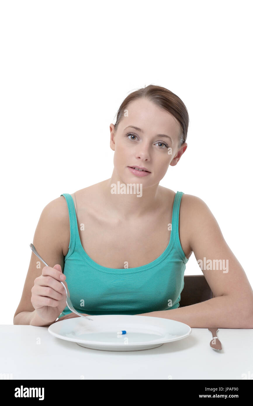 woman sitting at a tablet about to eat a single tablet Stock Photo - Alamy