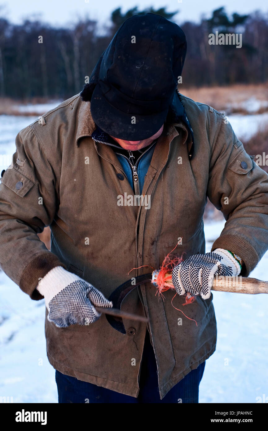 Man sharpening sickle hi-res stock photography and images - Alamy