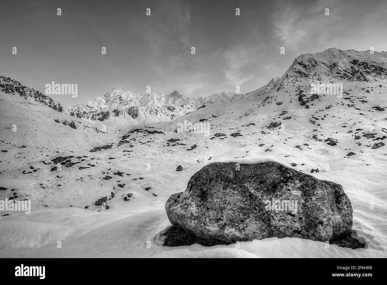 Stone rock in snow Black and White Stock Photos & Images - Alamy