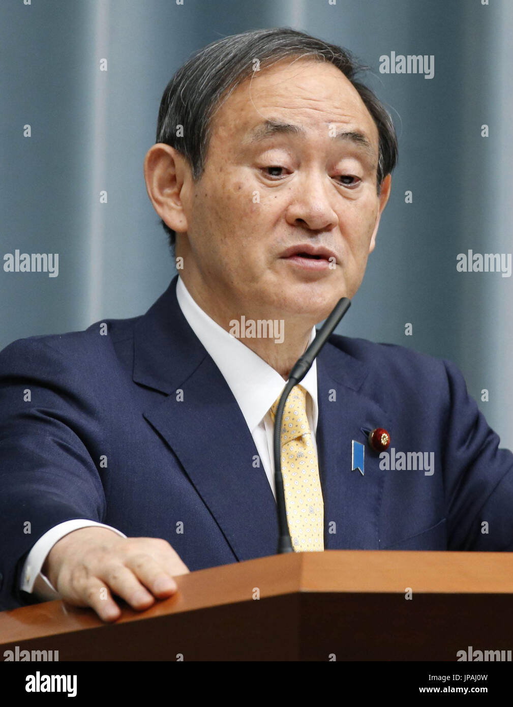 Japanese Chief Cabinet Secretary Yoshihide Suga tells a press ...
