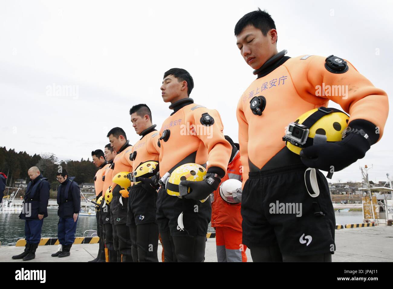 Japan Coast Guard divers offer silent prayers at the northeastern Japan ...
