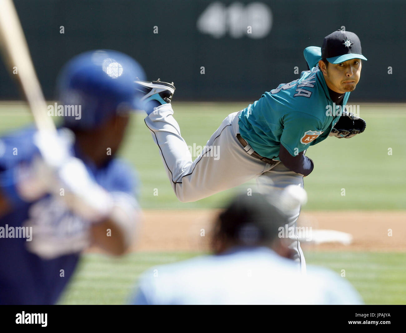 Hisashi Iwakuma of the Seattle Mariners gives up three runs and eight ...