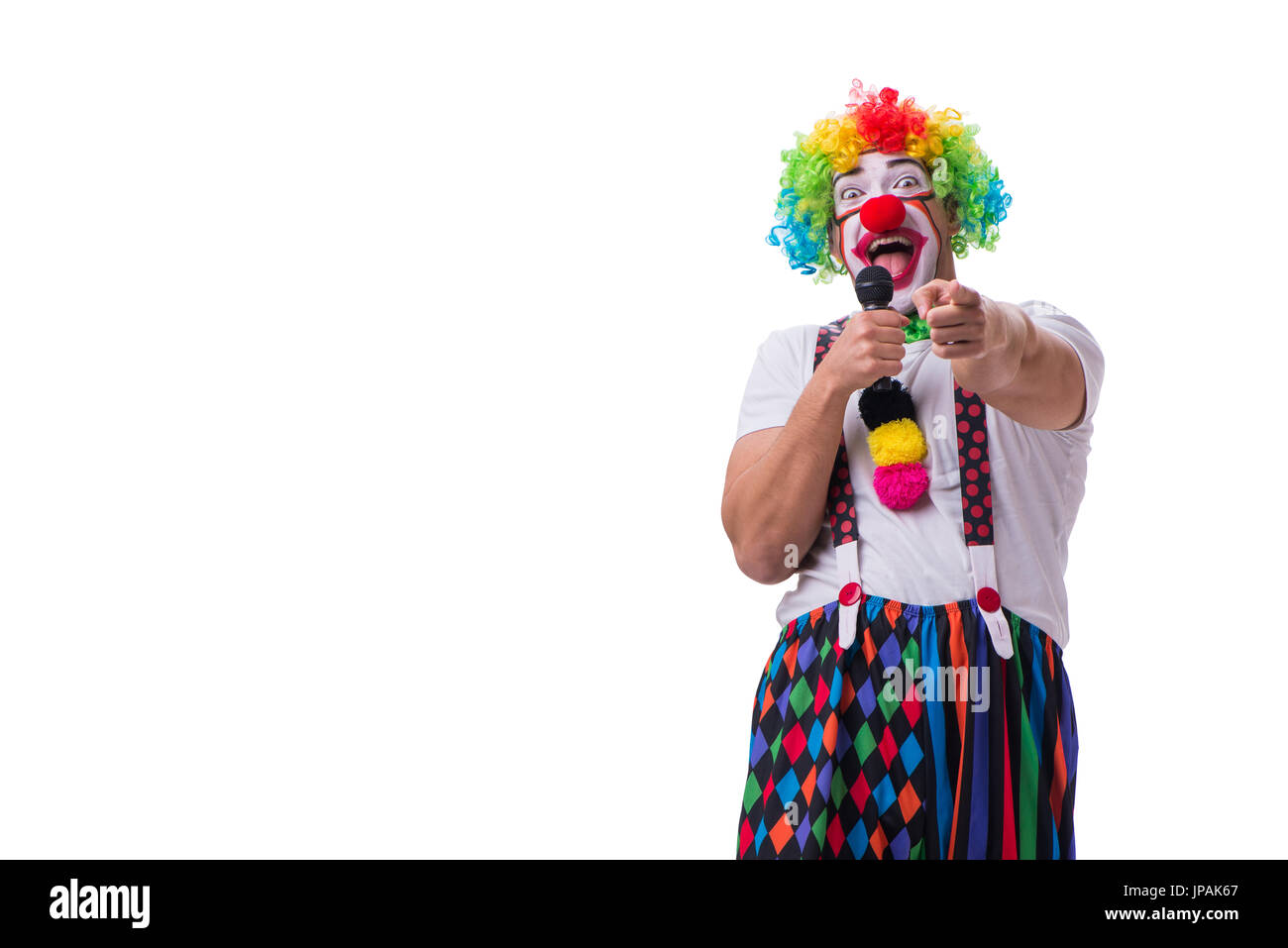 Funny clown with a microphone singing karaoke isolated on white ...