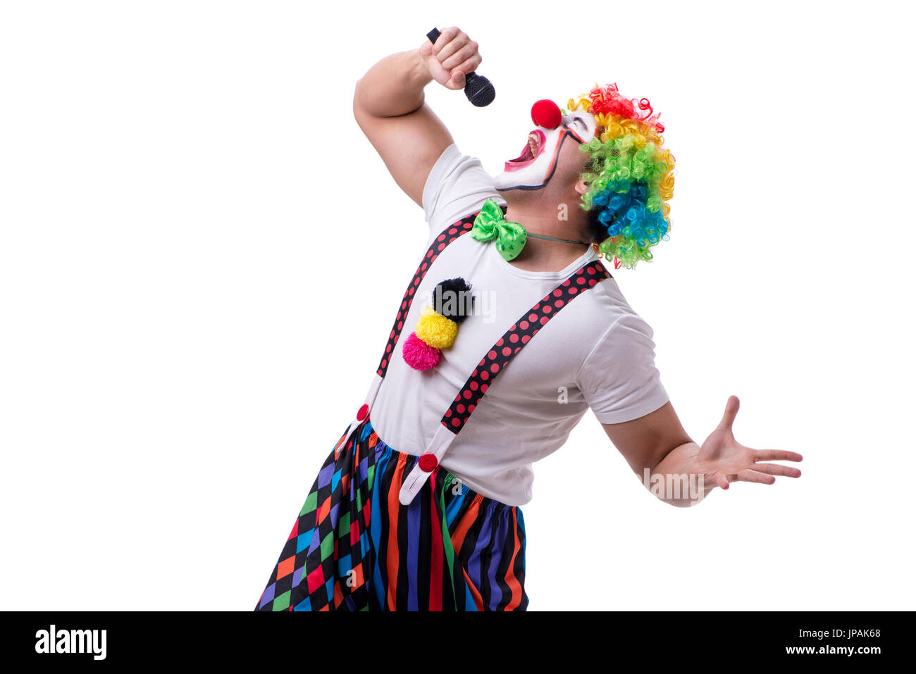 Funny clown with a microphone singing karaoke isolated on white ...