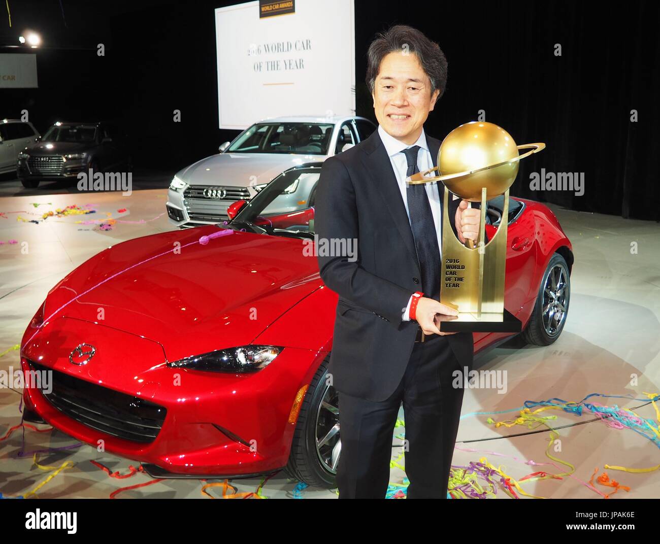 Masahiro Moro, president and CEO of Mazda Motor of America Inc., holds ...