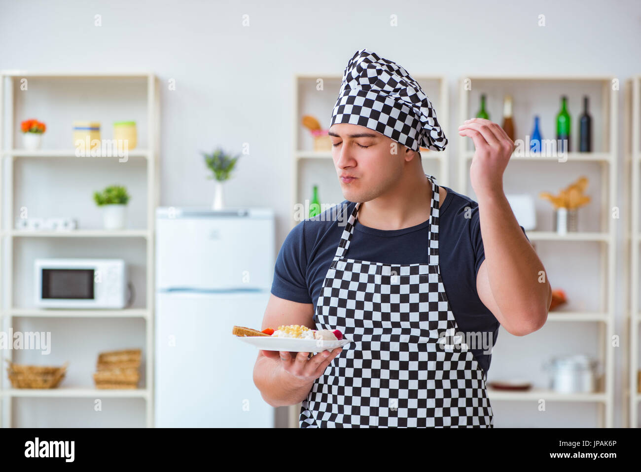 Chef cook cooking a meal breakfast dinner in the kitchen Stock Photo ...