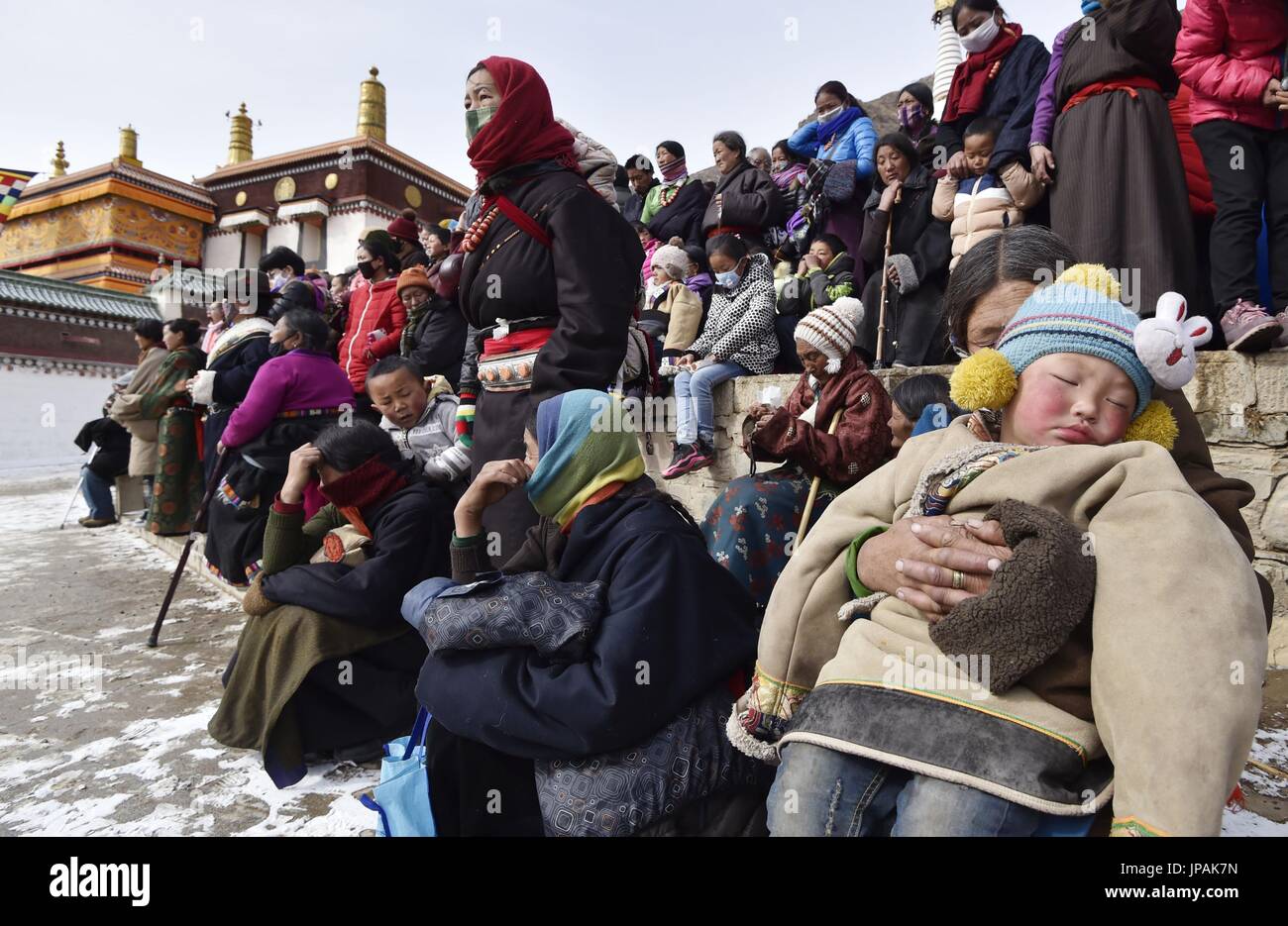 Tibetan people gather to watch cham, a Tibetan masked dance, to ...