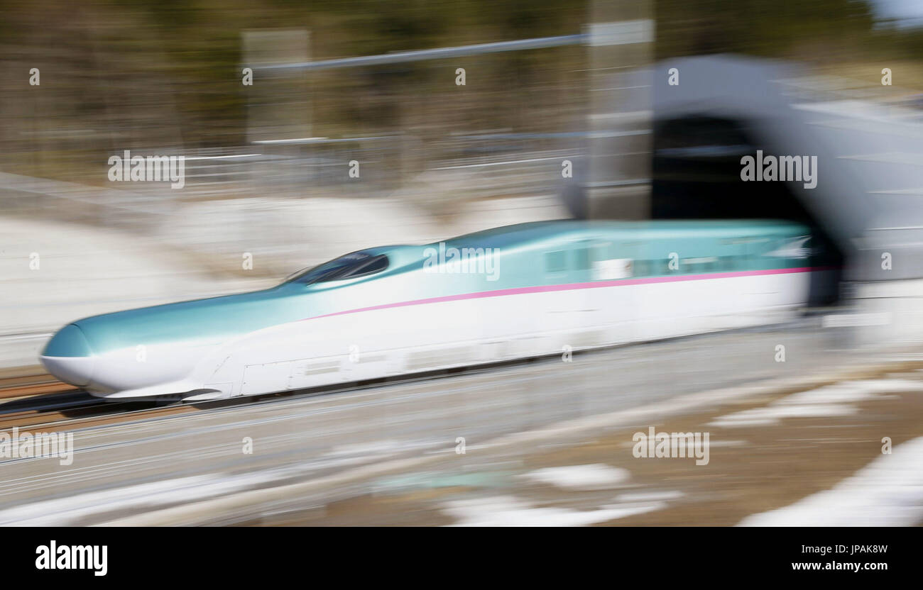Photo shows a shinkansen bullet train running like the wind in the town ...