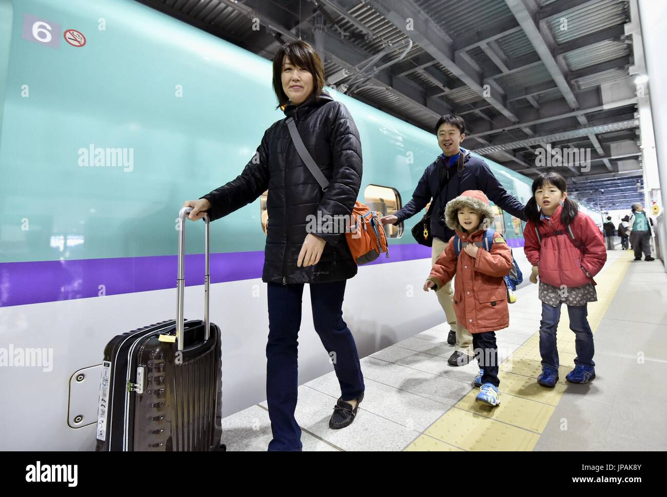 A family board the first shinkansen bullet train bound for Tokyo at JR ...