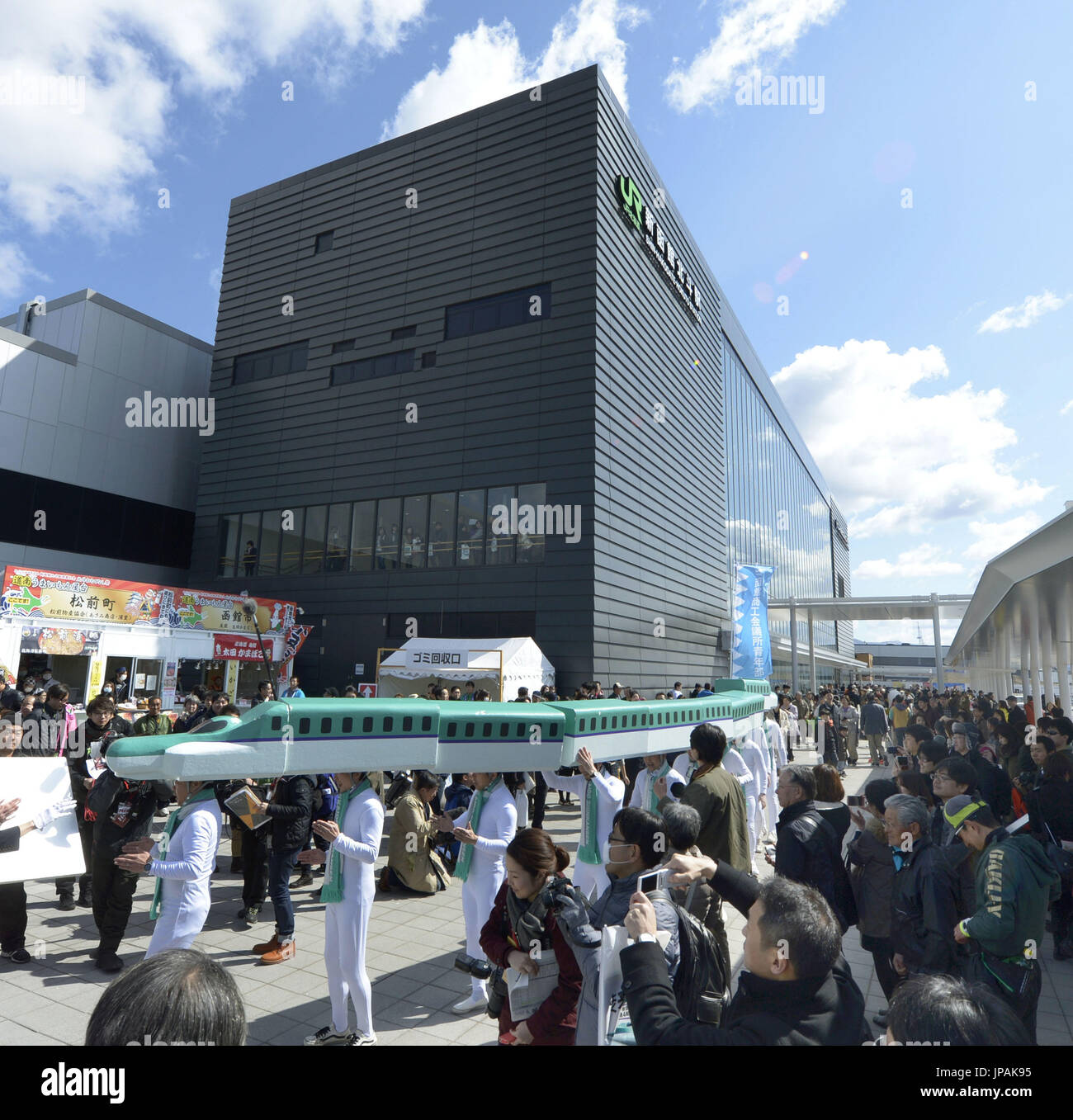 People, including those dressed as a Hokkaido Shinkansen bullet rain ...