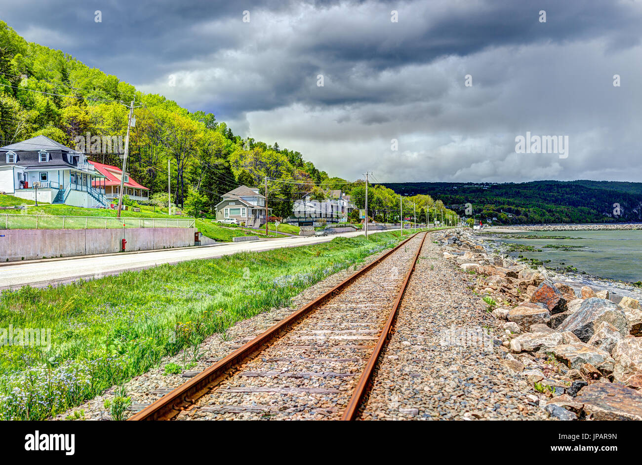 Railroad with Saint Lawrence river in Saint-Irenee, Quebec, Canada in ...