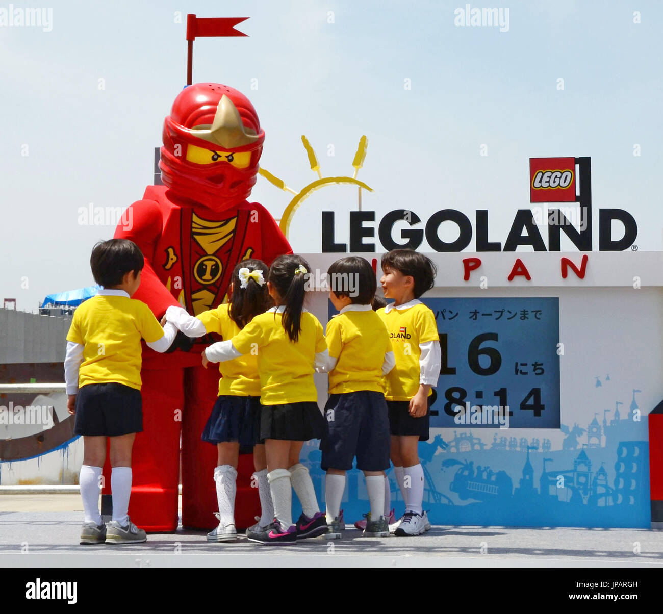 Kindergarten pupils play with a Lego mascot during a ceremony in Nagoya ...