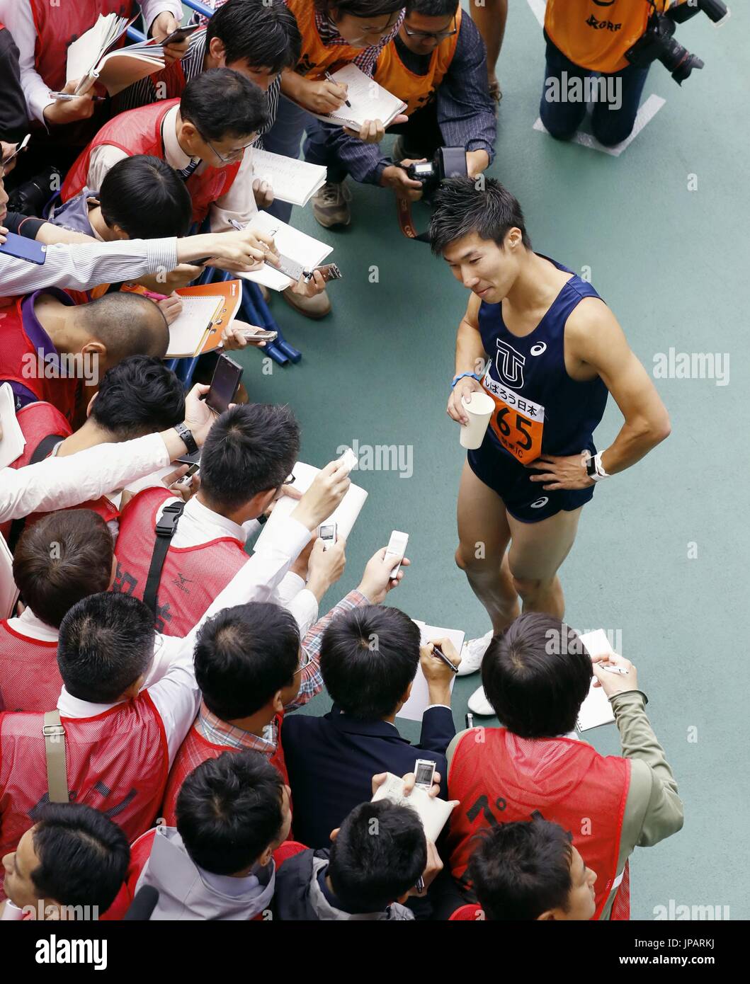 Japanese sprinter Yoshihide Kiryu is surrounded by reporters after ...