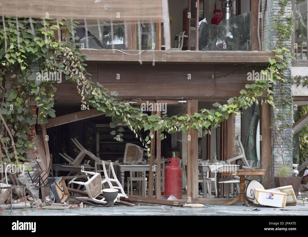 Chairs remain upturned in the Holey Artisan Bakery cafe in Dhaka on ...